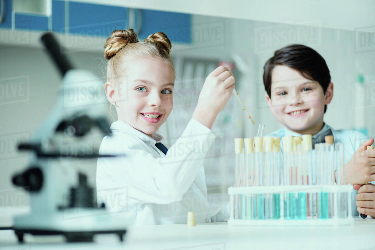 Schoolchildren with science lab equipment in chemical lab, scientists ...