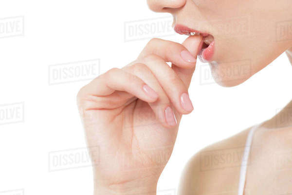 Close-up partial view of seductive young woman biting thumb isolated on ...