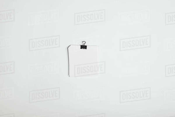 top view of little stack of white note papers with binder clip isolated ...