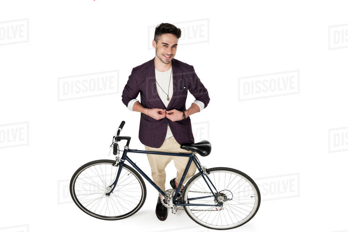 Stylish young man standing with bicycle and smiling at camera - Royalty ...