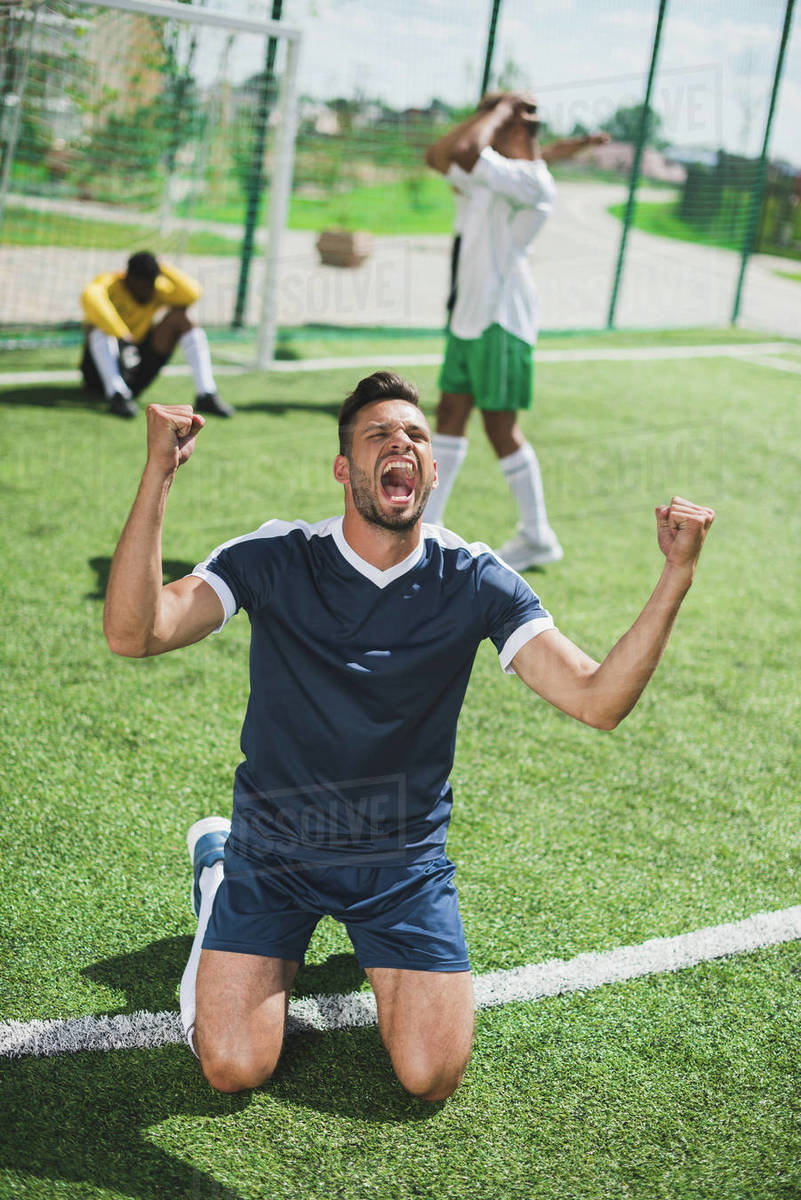 Happy soccer player celebrating goal during soccer match - Royalty-free ...