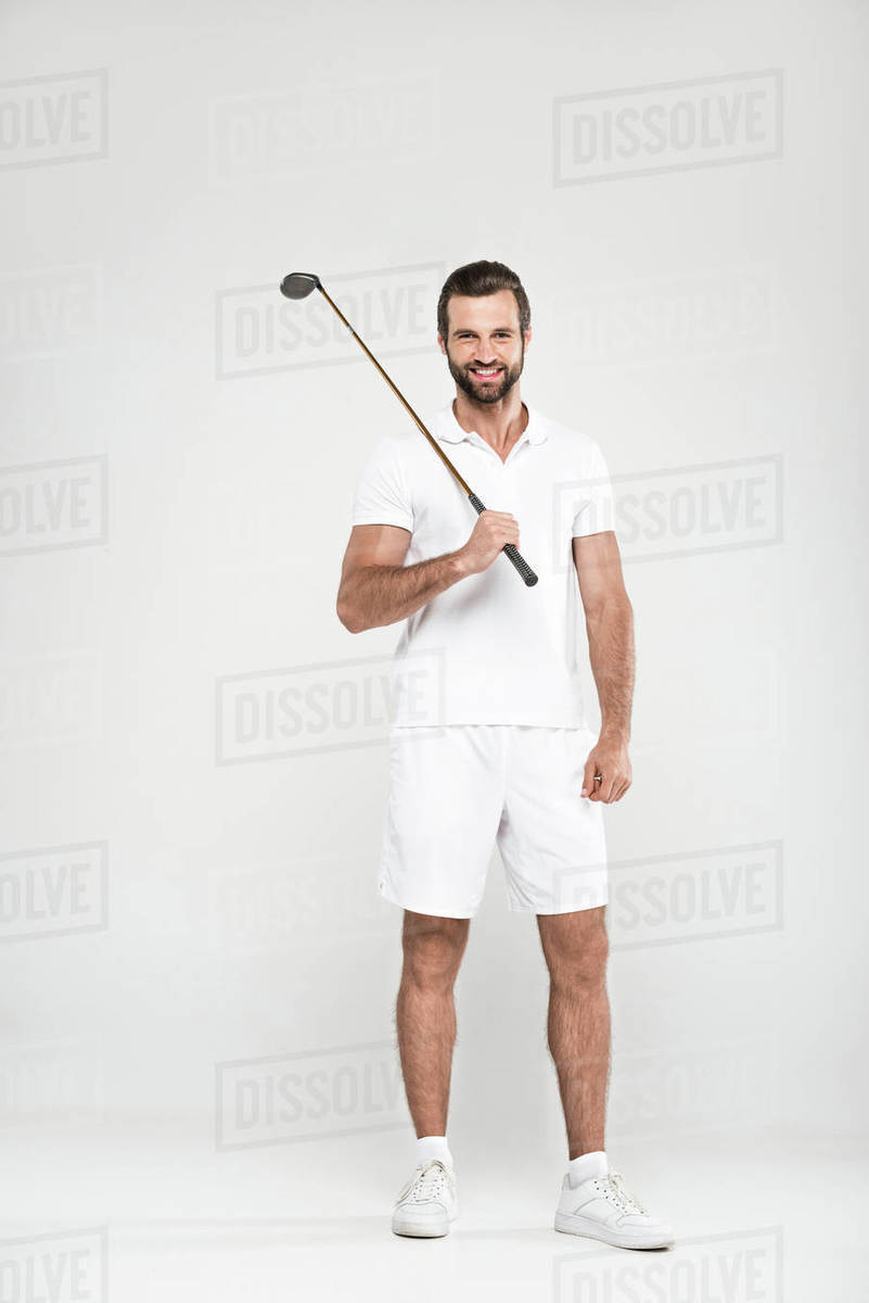 Cheerful male golfer in white sportswear with golf club, isolated on ...