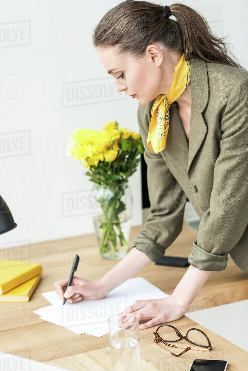Attractive stylish businesswoman taking notes at workplace - Royalty ...