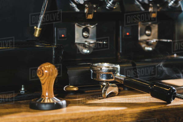 Close-up view of modern coffee machine on wooden table in coffee shop ...