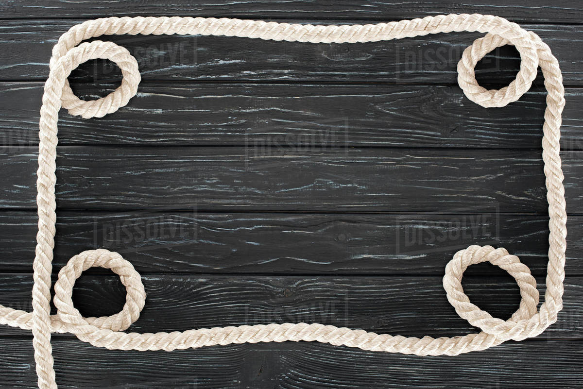 Top view of white nautical rope on dark wooden surface - Royalty-free ...