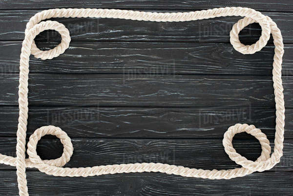 Top view of white nautical rope on dark wooden surface - Royalty-free ...