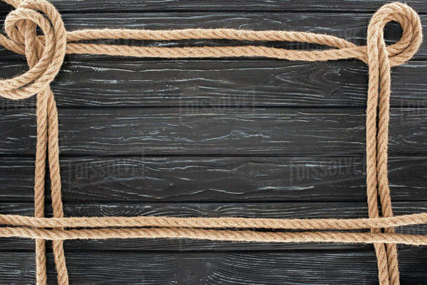 Top view of brown ropes on dark wooden surface - Royalty-free Stock ...