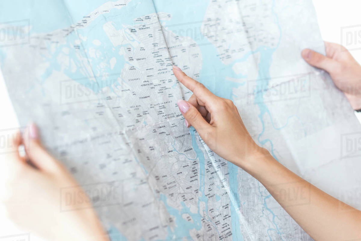 Partial view of tourists pointing at map, isolated on white - Royalty ...