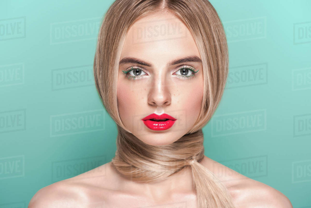 portrait of beautiful young naked woman with long hair around neck looking at camera isolated on ...