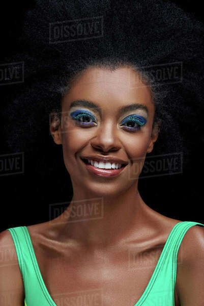 portrait of smiling african american model with bright blue eyes ...