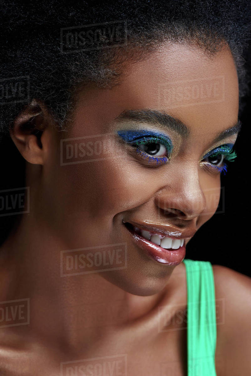 portrait of smiling african american model with bright blue eyes ...