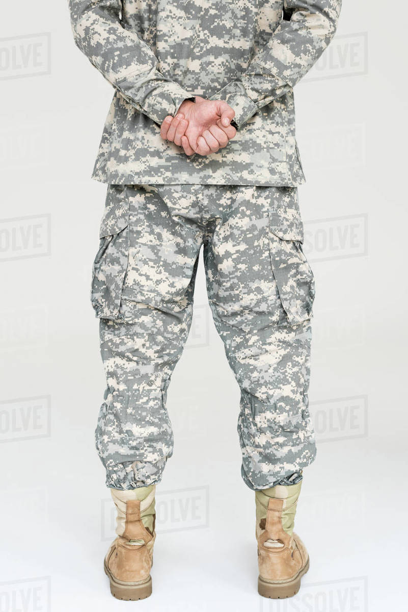 cropped shot of soldier in military uniform and boots isolated on grey ...