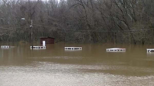 Shot of fast moving flood waters as it moves over a rural field. - HD ...
