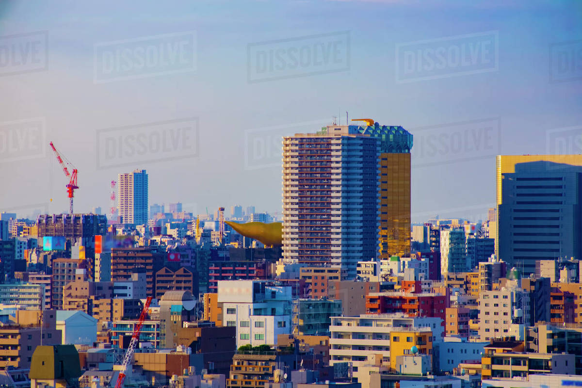 Crane at top of the building in the city long shot. Taito district ...