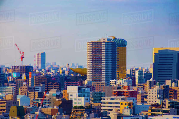 Crane at top of the building in the city long shot. Taito district ...