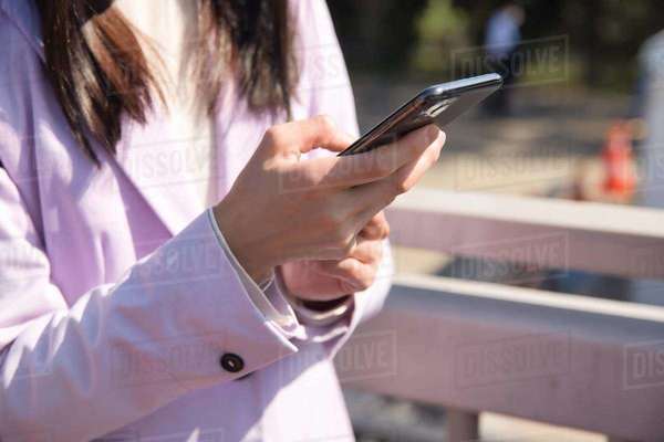 Body parts of hands using smartphne by Japanese woman at the street ...