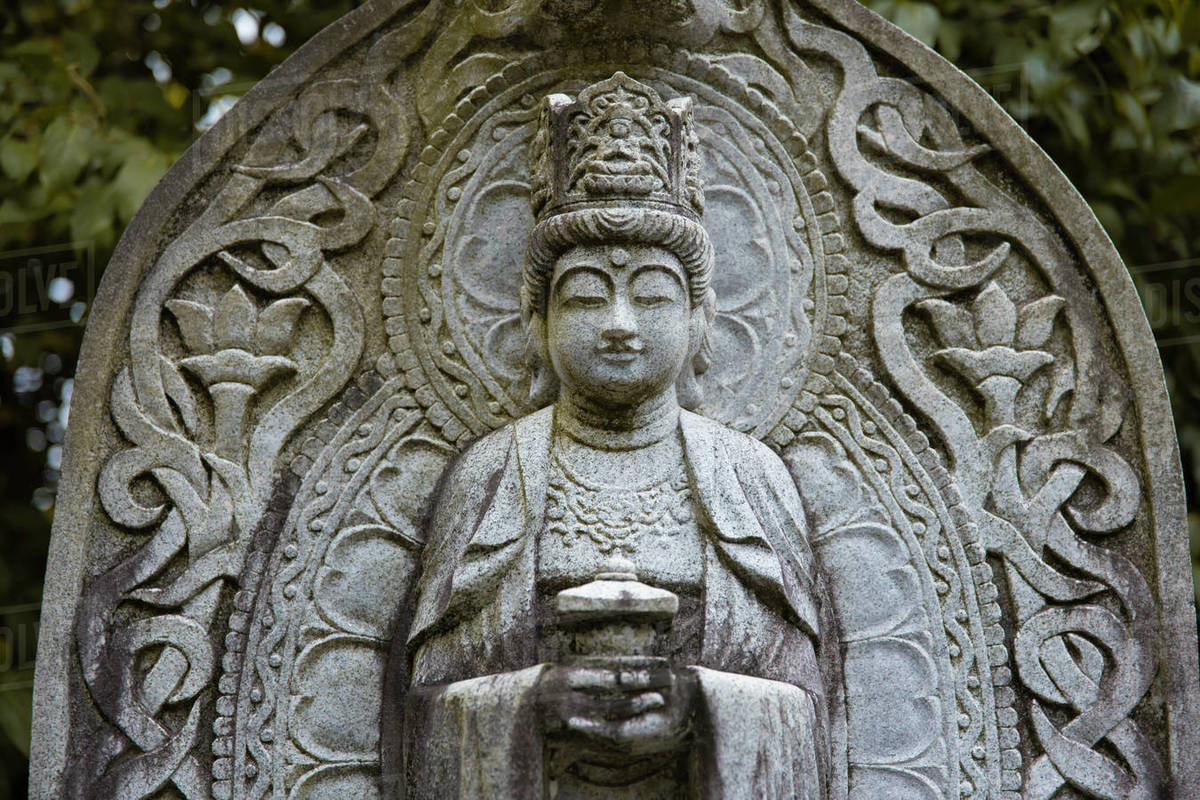 A religious stone statue of Maitreya at Japanese buddhism temple ...