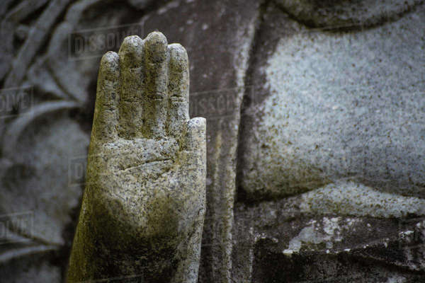 A religious stone statue of Medicine Buddha at Japanese buddhism temple ...