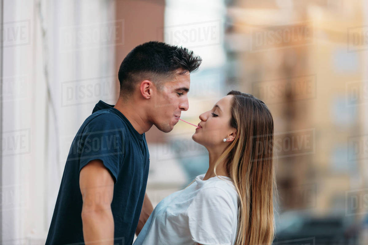 Couple sharing bubble gum on balcony, Lleida, Spain - Royalty-free ...