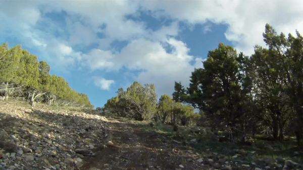 ATV driving up steep, rough and difficult mountain trail with rocks and ...