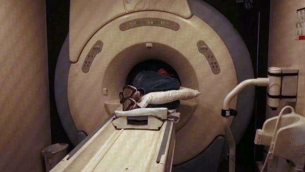 Hospital emergency MRI on man patient. Man lays in Magnetic Resonance ...