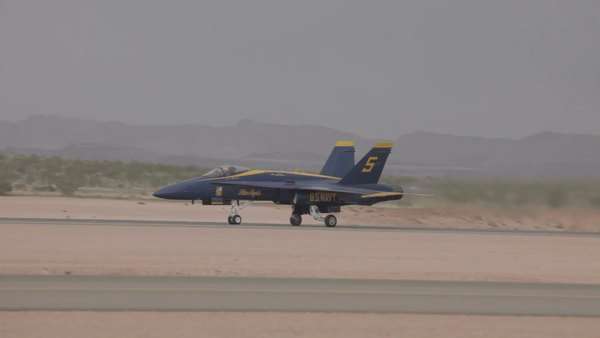 Navy Blue Angel demonstration fighter jet takeoff on runway with steep ...