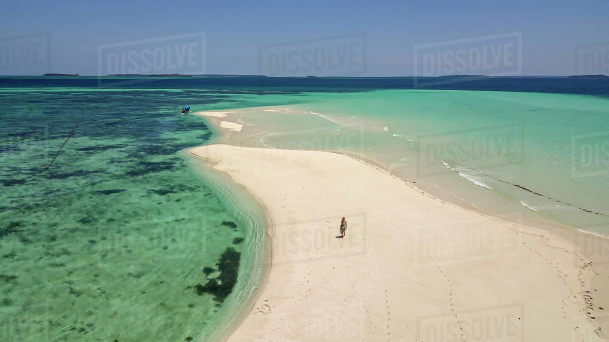 Aerial view of woman walking on Ngurtafur beach, Kei islands, Maluku ...