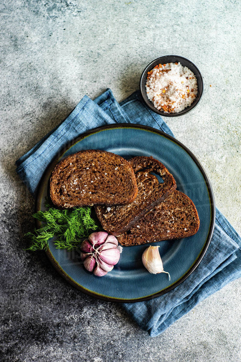 Overhead view of toasted rye bread with garlic and sea salt - Royalty ...