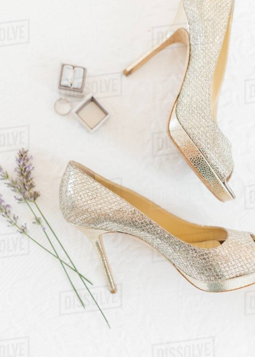 Overhead view of a wedding ring, engagement ring, high heel platform ...