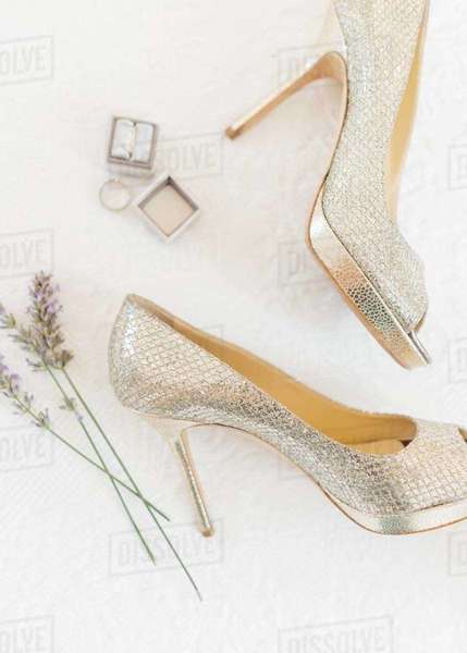 Overhead view of a wedding ring, engagement ring, high heel platform ...