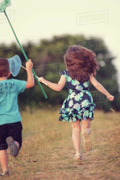 Boy and girl chasing butterflies, Sinemorets, Bulgaria - Royalty-free ...