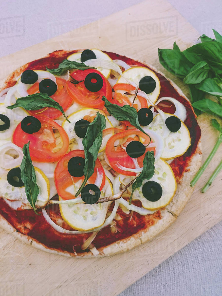 Elevated view of fresh cooked pizza with herbs - Royalty-free Stock ...