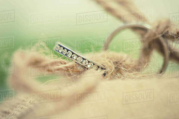 Close-up of two wedding rings tied with piece of string - Royalty-free ...