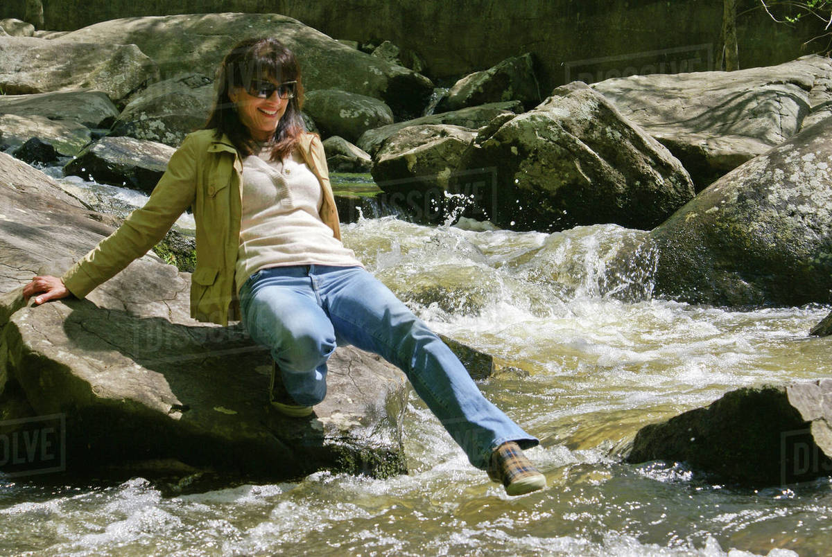 Woman trying to cross a stream, Saint Peters, Pennsylvania, America ...