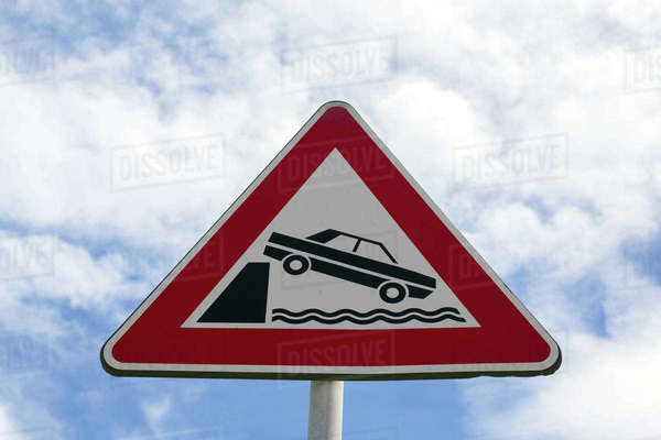 Car falling in water warning traffic sign - Stock Photo - Dissolve