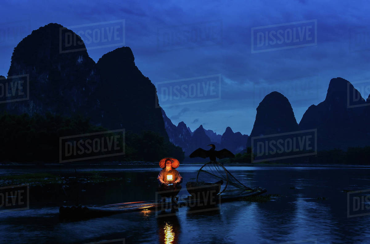 Fisherman on raft on Li river at night, Guilin, Guangxi, China ...