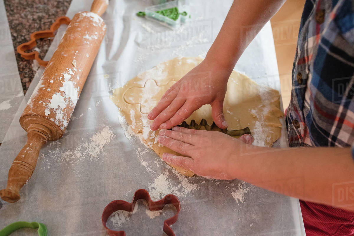 Boy making Christmas cookies - Stock Photo - Dissolve