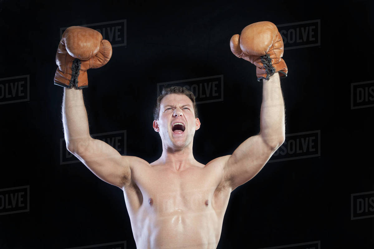 Boxer cheering with hands raised in air - Stock Photo - Dissolve