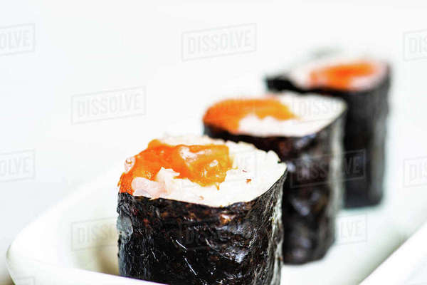 Close-up of three sake maki rolls on a plate - Stock Photo - Dissolve