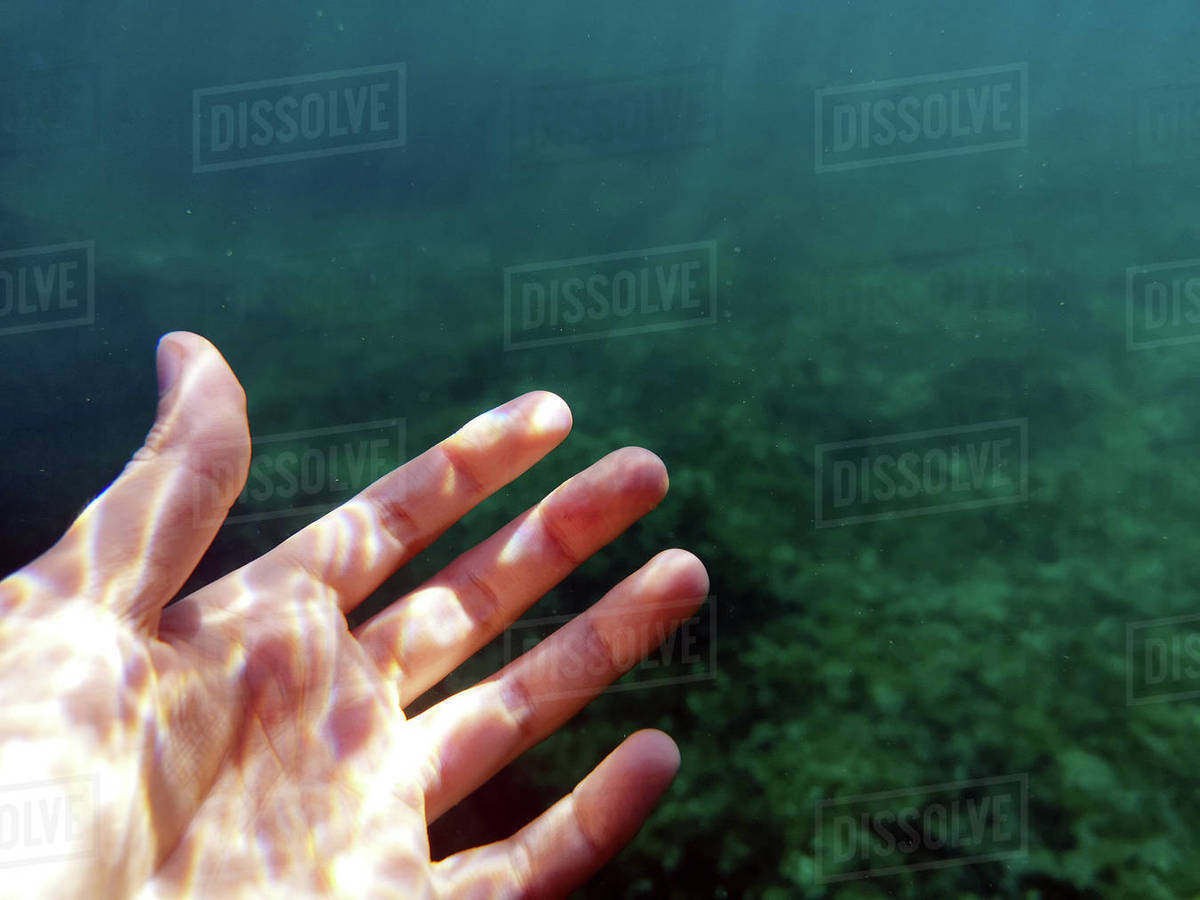 Close-up of a woman's hand underwater in sea, Bugibba, Malta - Royalty ...
