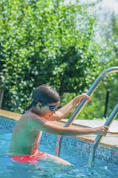 Boy getting out of a swimming pool, Bulgaria - Stock Photo - Dissolve