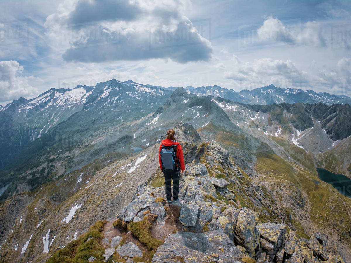 Woman standing on a mountain ridge, Austrian Alps, Bad Gastein ...