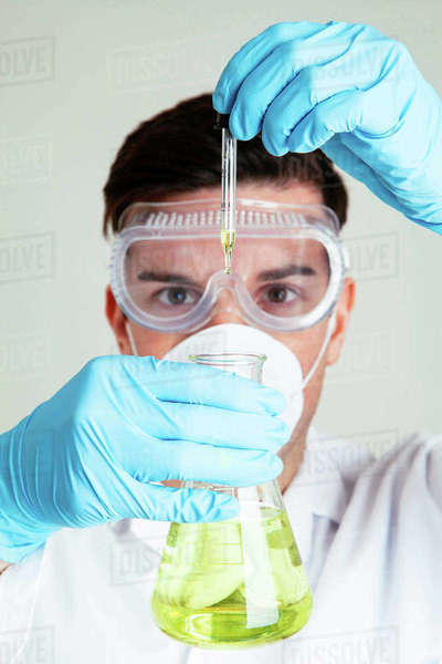 Scientist holding conical flask and pipette - Royalty-free Stock Photo ...