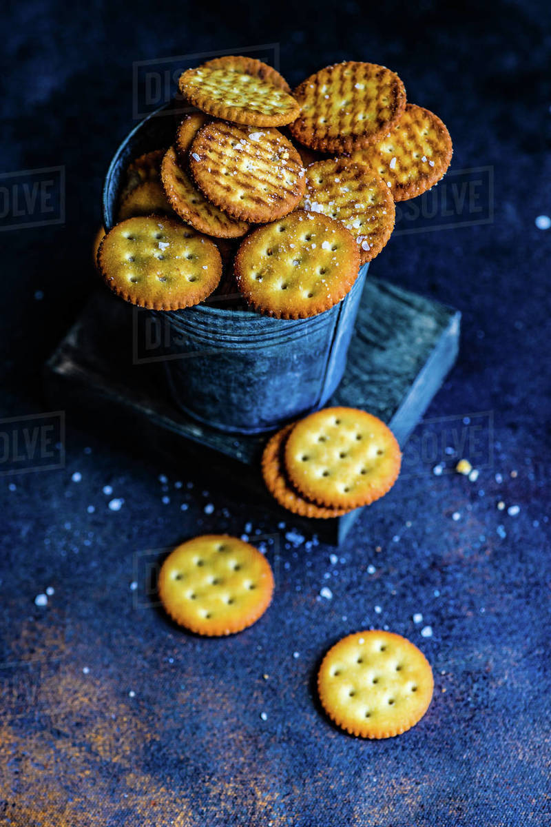 Salted cracker cookies in a metal bucket on a table - Royalty-free ...