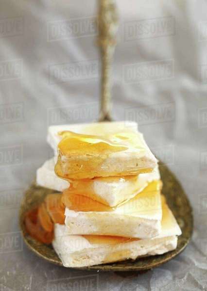 Plain Nougat with drizzled honey - Stock Photo - Dissolve