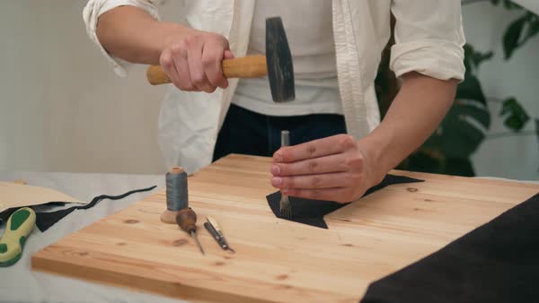 Close up craftman man work with leather, produce shoes or fashion bag ...