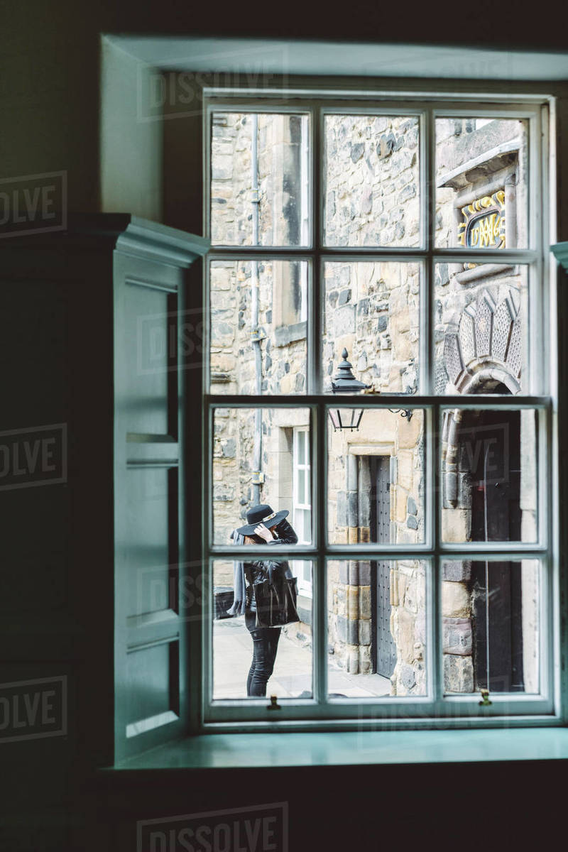 View through old window frame with aged stone building behind in soft ...