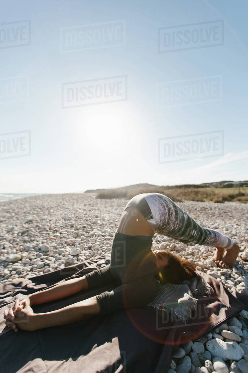 African American attractive young woman in yoga headstand posture in ...