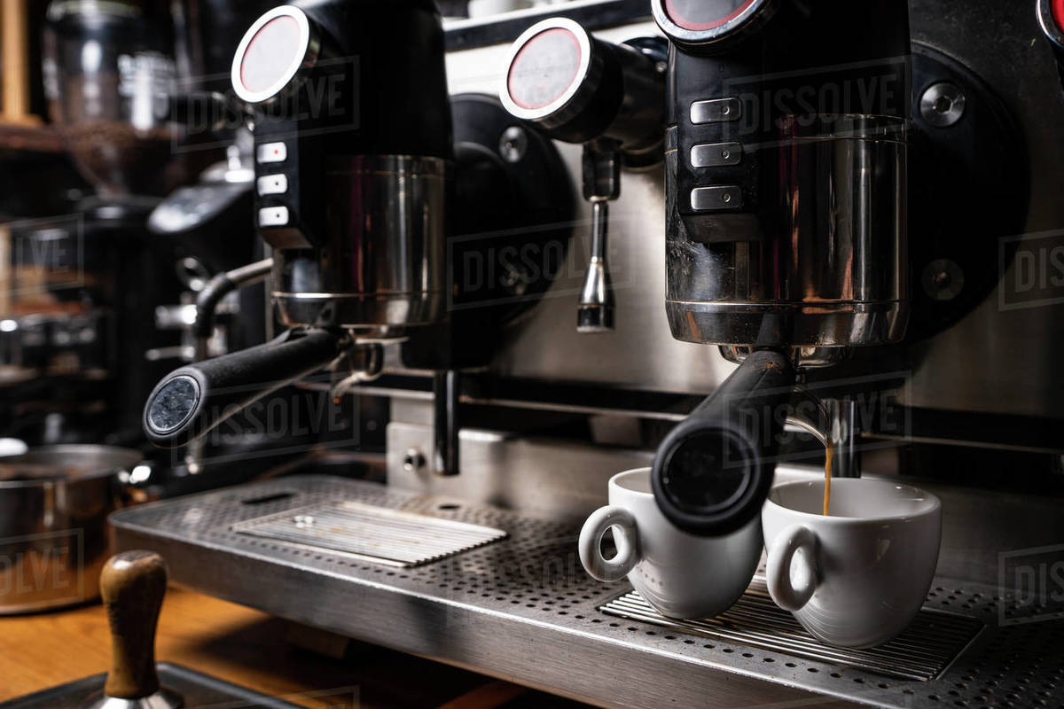 Professional coffee machine in restaurant dispensing freshly brewed ...