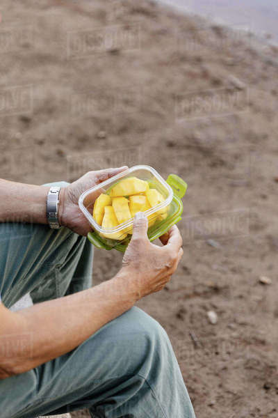 Detail of unrecognizable man eating mango fruit in the forest - Royalty ...